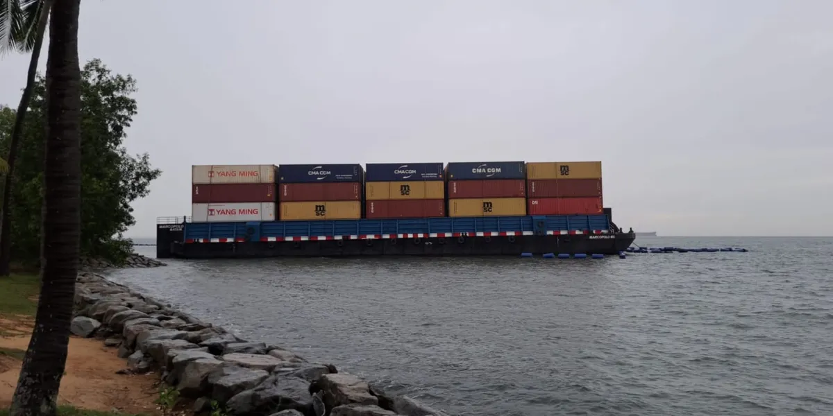 Container barge runs aground on Singapore beach